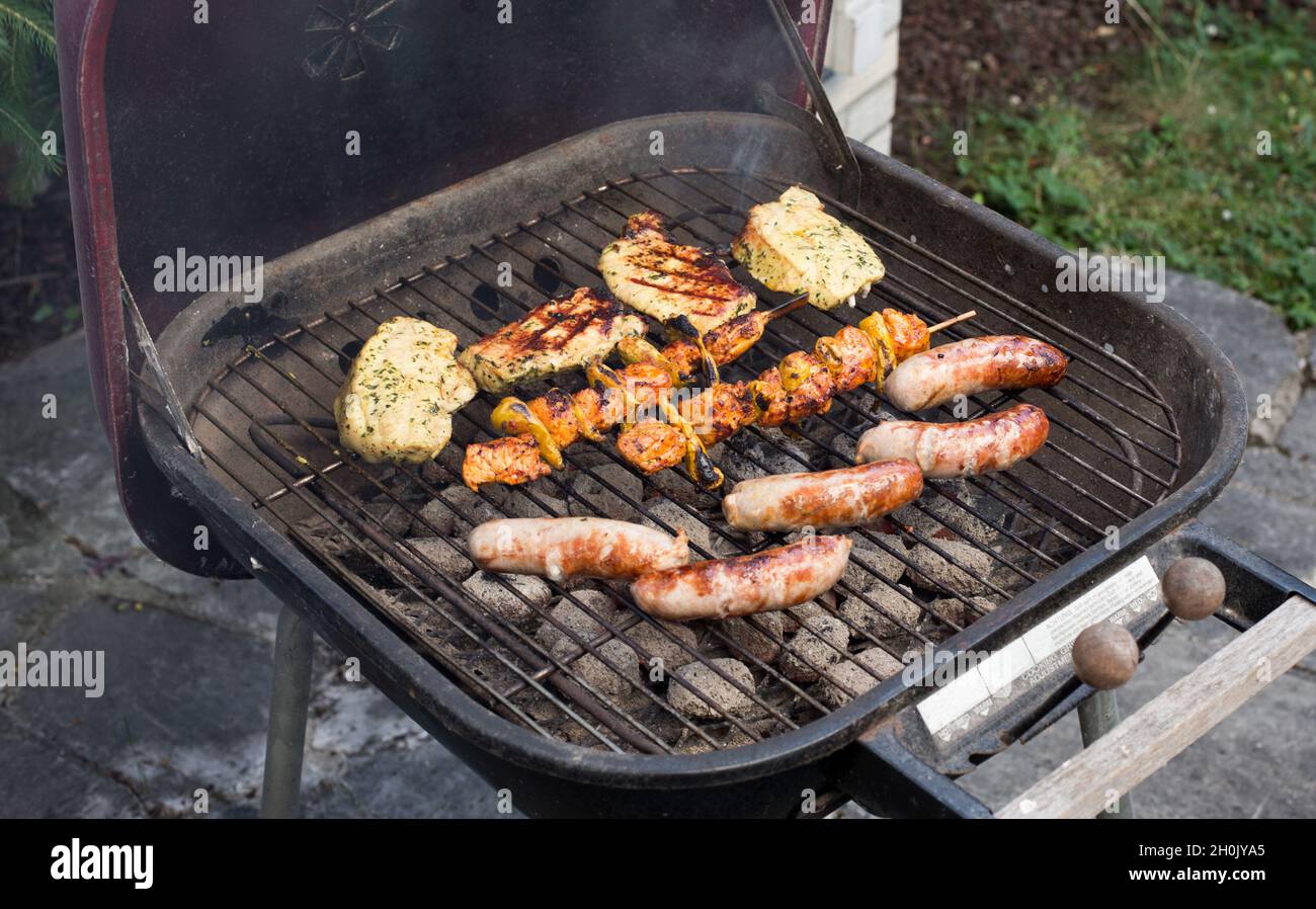 Grilled meat on charcoal barbecue in backyard Stock Photo - Alamy