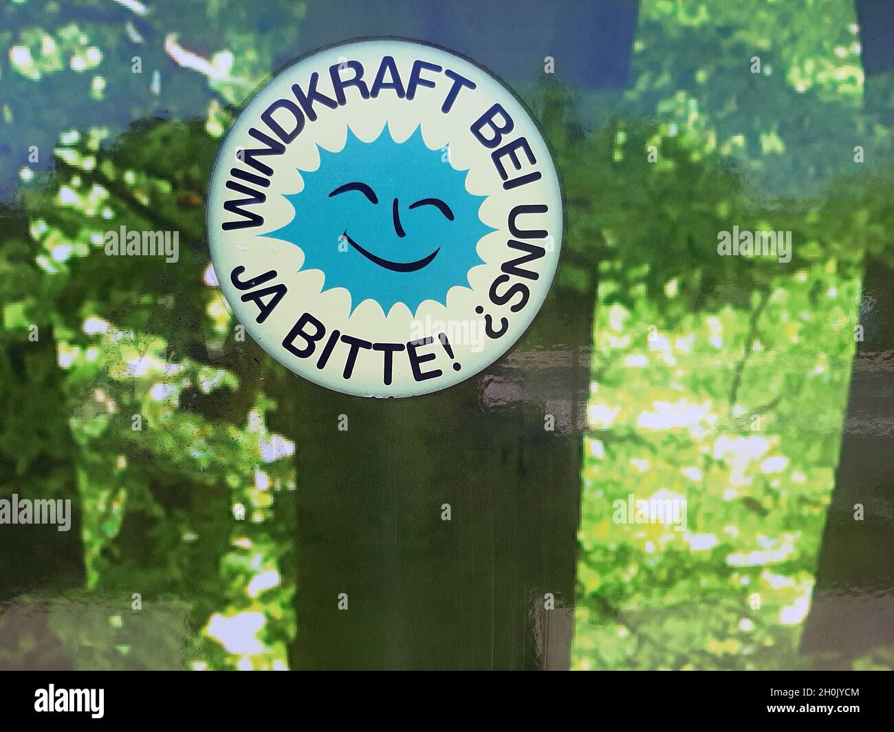 Wind power sticker with forest motif in the background Stock Photo - Alamy