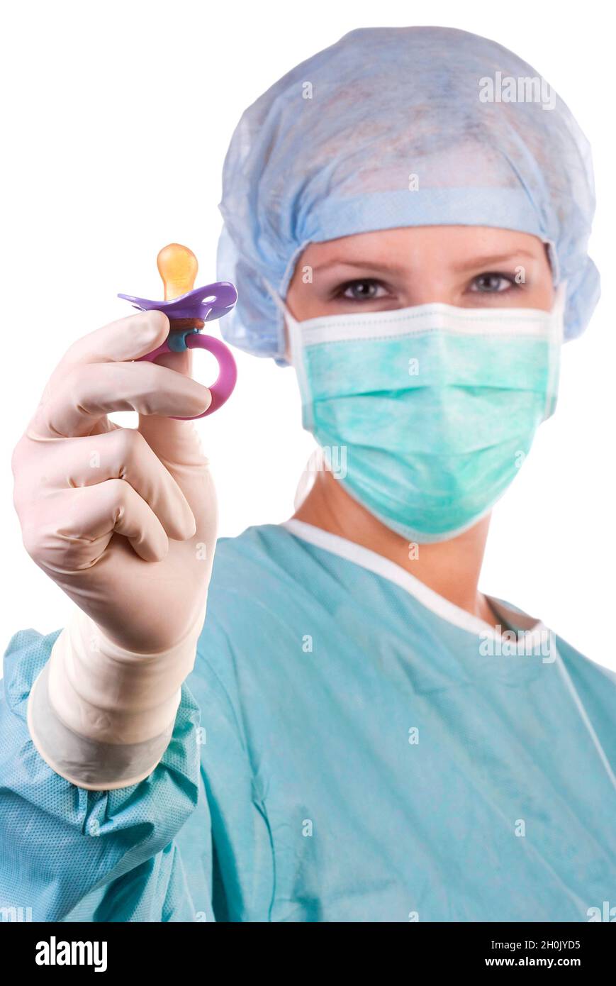 young operating room nurse with surgical mask and nurses cap holding a ...