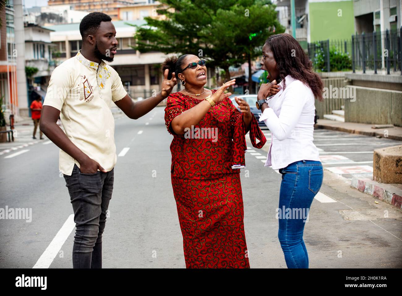 beautiful happy family standing and walking outdoors in the street ...