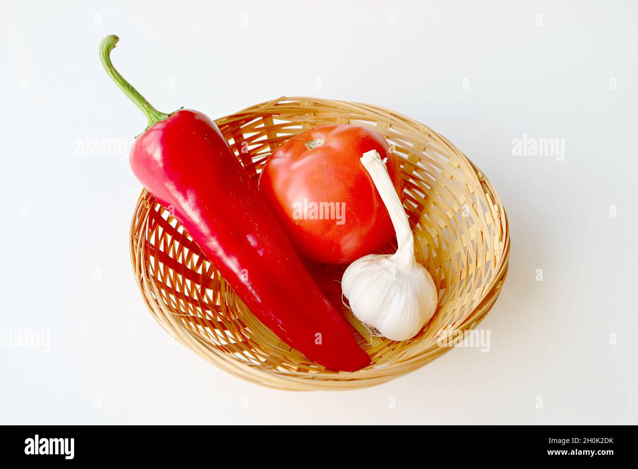 A basket of fresh Red Georgia Flame Sweet Pepper with tomato and garlic ...