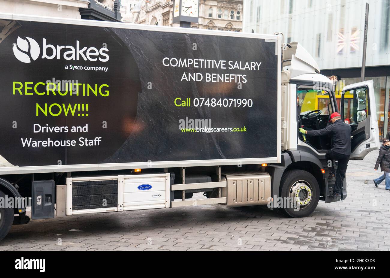 An advert for drivers and warehouse staff on the side of a lorry as a ...