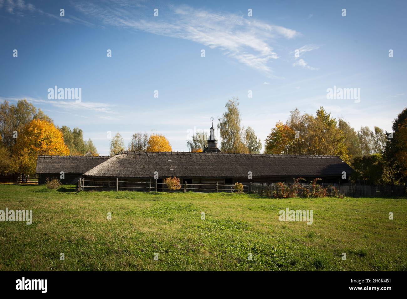 An old rustic wooden hut. In the background there is a rustic wooden ...