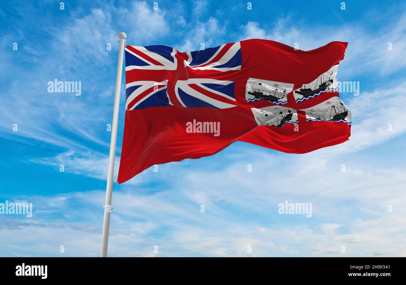 flag of Trinity House Ensign at cloudy sky background on sunset ...