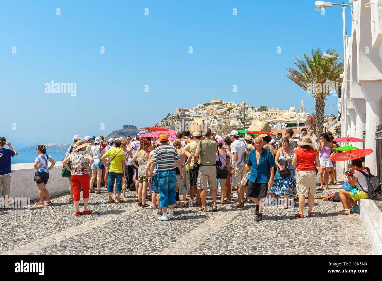 Tourist group on a guided tour at main town of island Thira. Santorini ...
