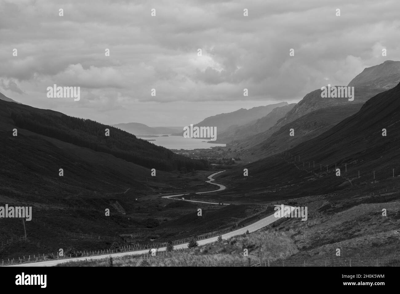 Beautiful black and white viewpoint with mountains and a long road in ...