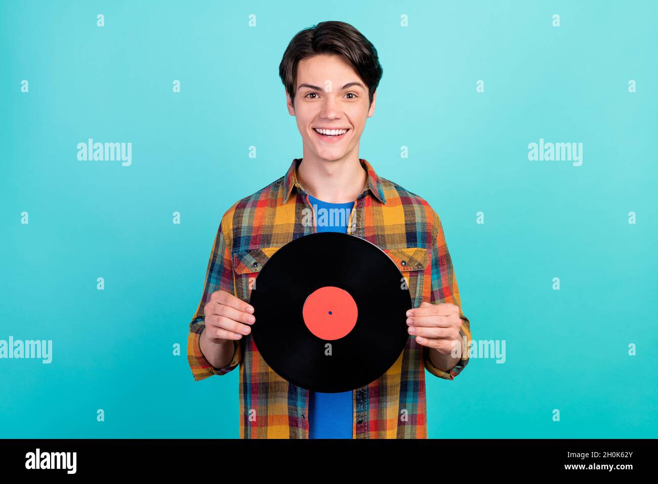 Photo of positive funny dj guy hold vinyl disk omg reaction wear plaid ...