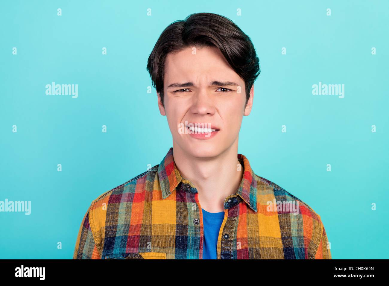 Photo of sad unsure troubled puzzled confused guy wear checkered shirt ...