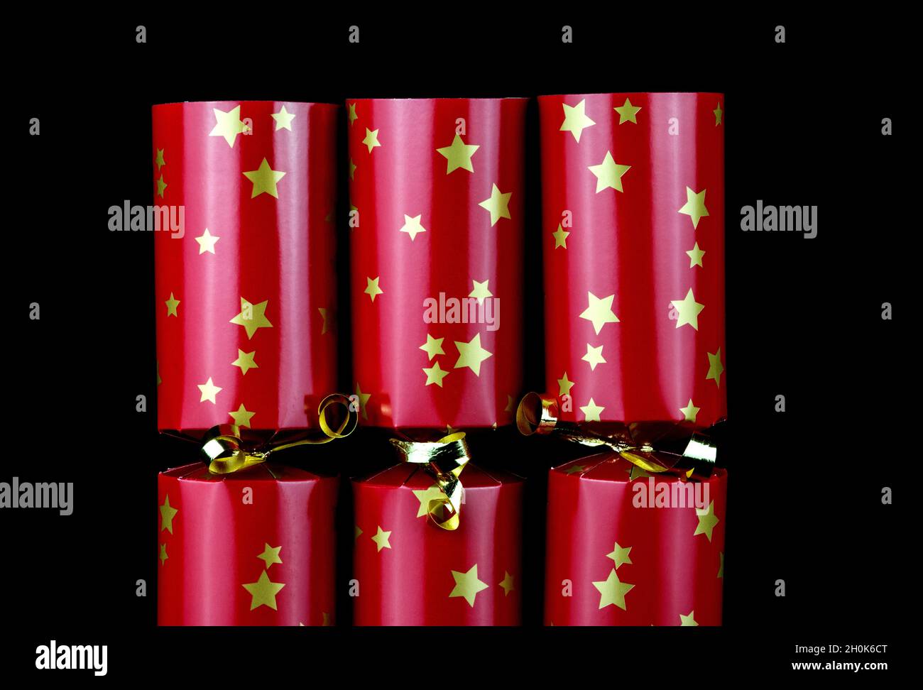Partial view of three red christmas crackers isolated on a black ...