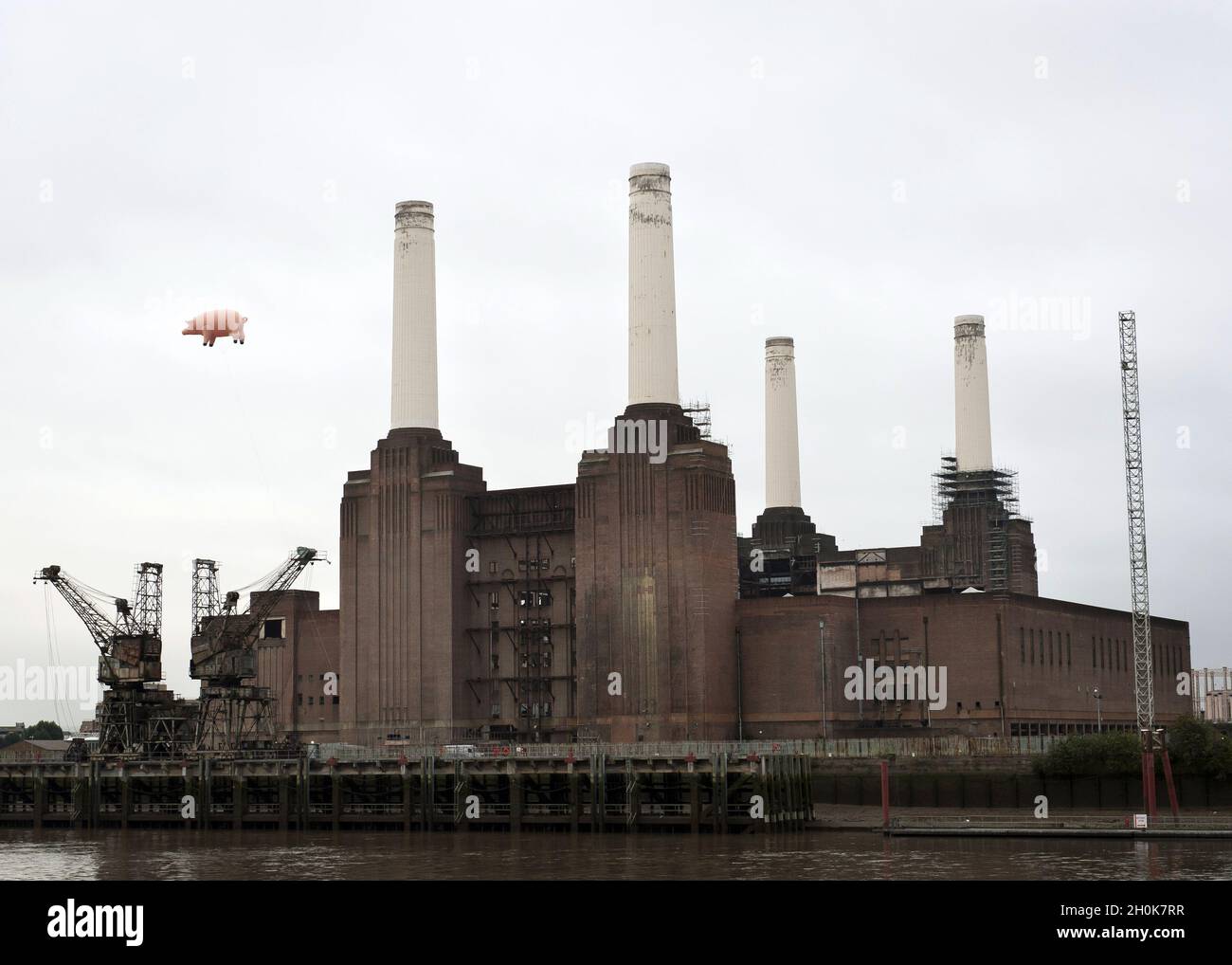 A giant inflatable pig flies above Battersea Power Station on the banks ...
