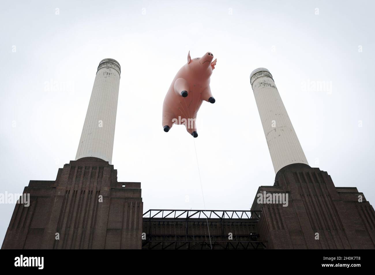 A giant inflatable pig flies above Battersea Power Station on the banks ...