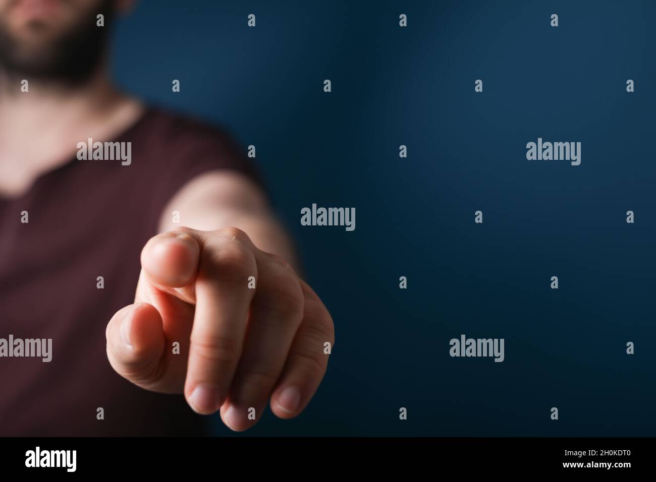 Shallow focus of a young man finger pointing touch a modern blue Stock ...