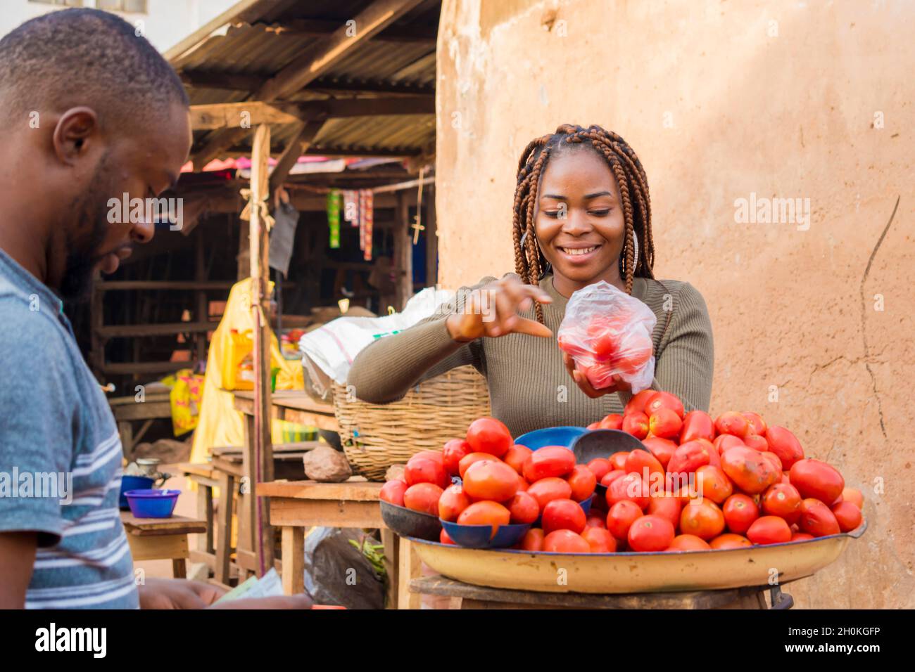 beautiful african trader packaging her goods for her customer Stock ...