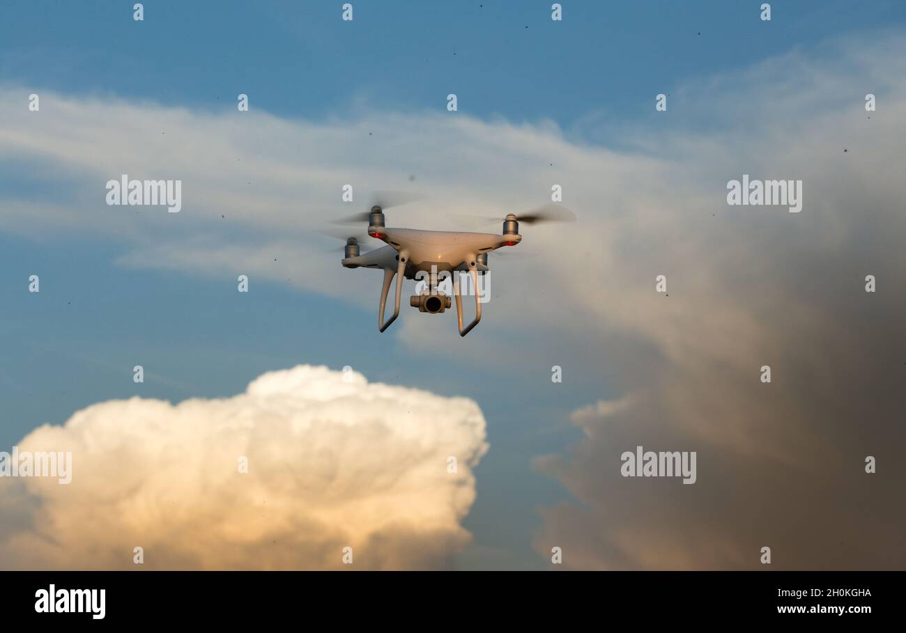 Drone flying outdoor with blue sky and clouds in background Stock Photo ...
