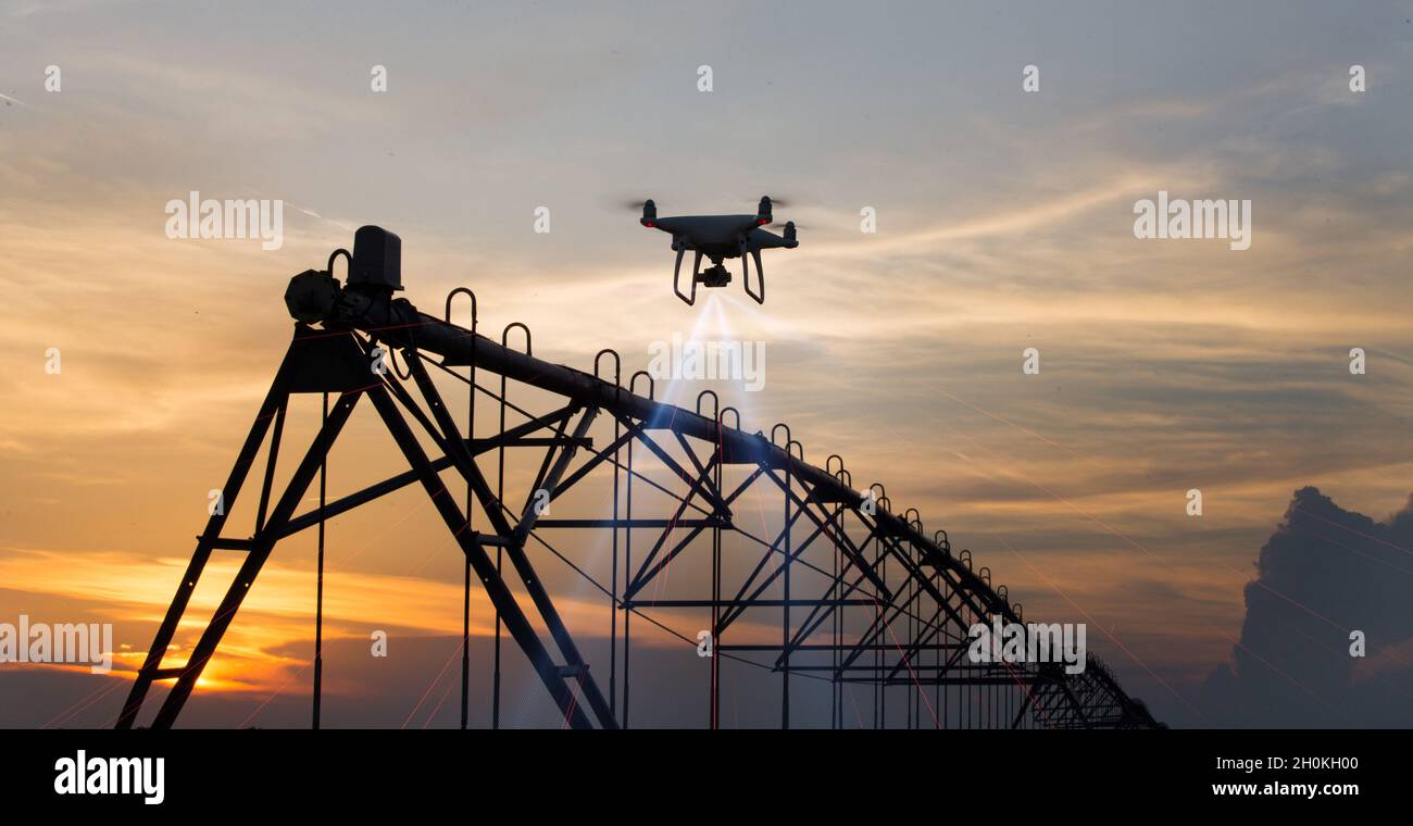 Drone flying and mapping field in front of irrigation system. Farmland ...