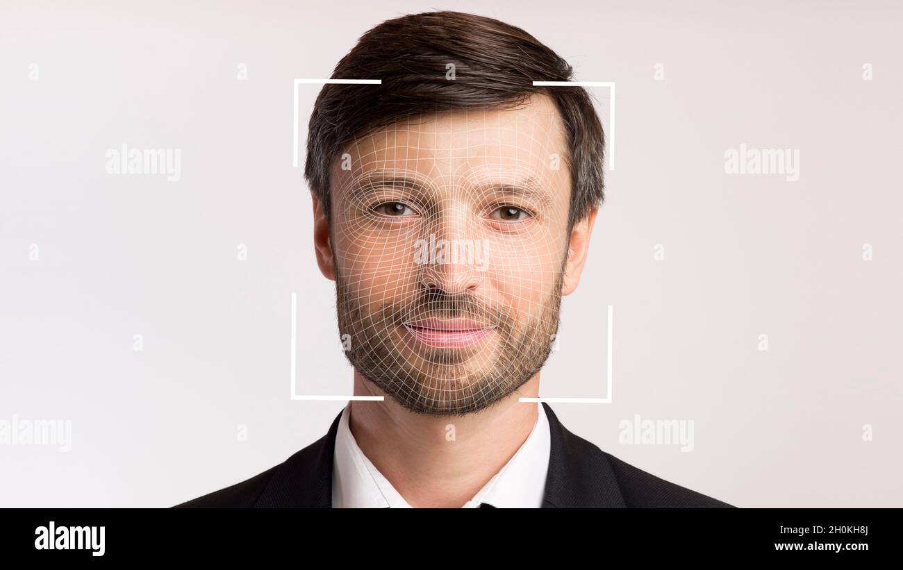 Friendly millennial businessman with stubble in suit scanning for ...