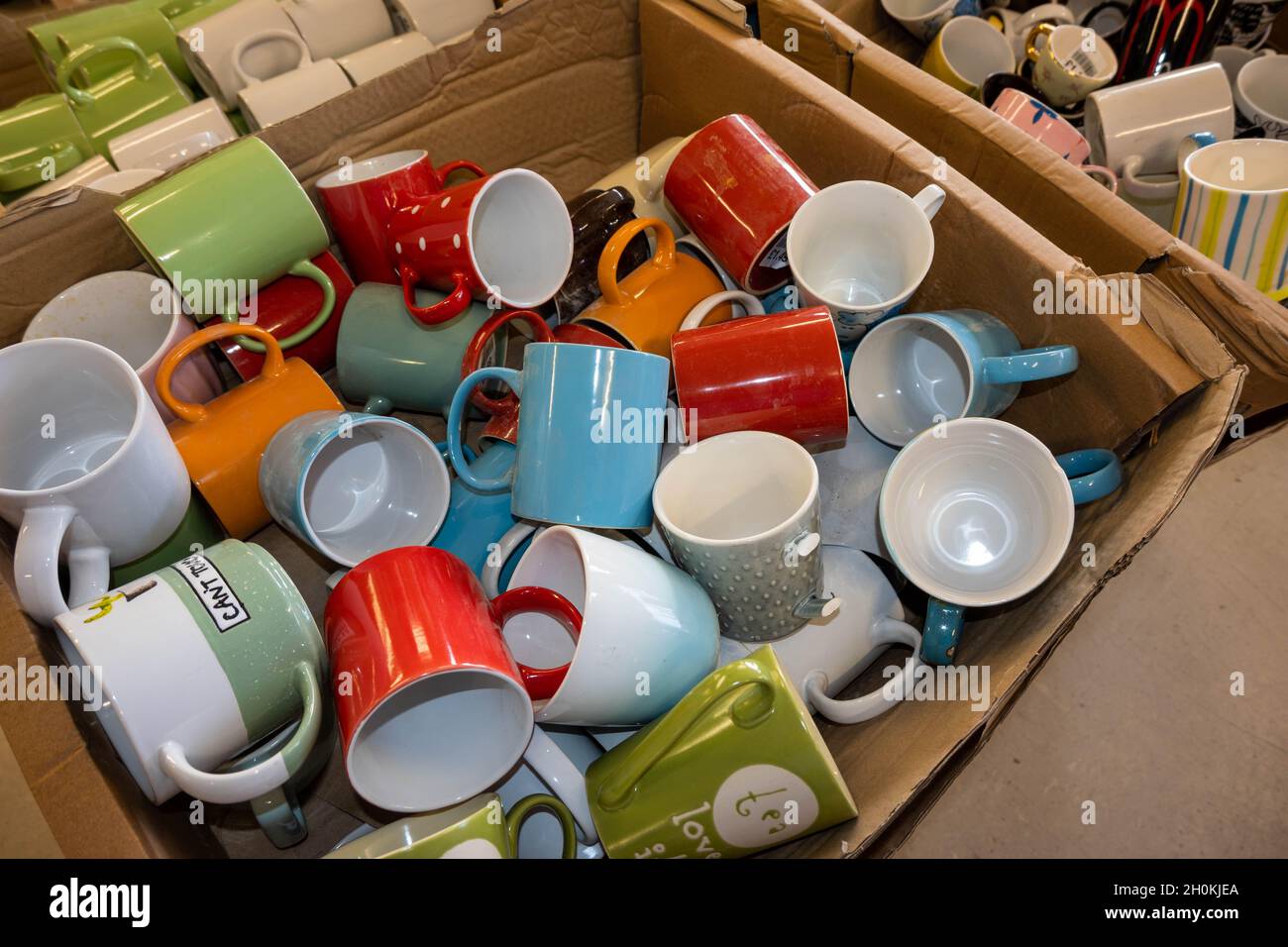 cardboard box of new assorted mugs in different styles and colours in a ...