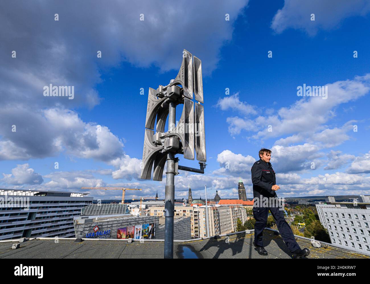 Dresden, Germany. 13th Oct, 2021. A firefighter walks past a siren on ...