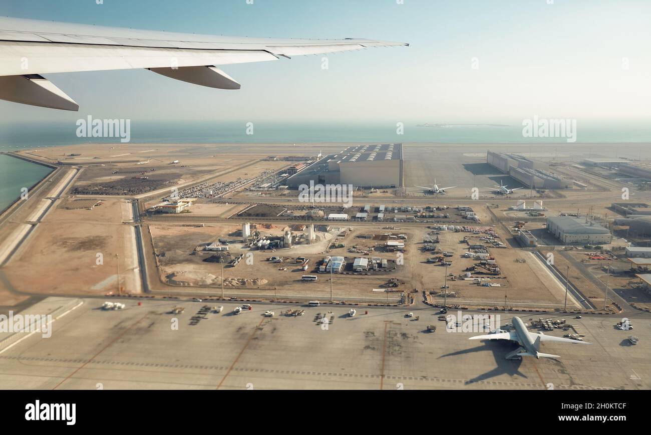 Wing of a plane above an airport, transport industry concept Stock ...