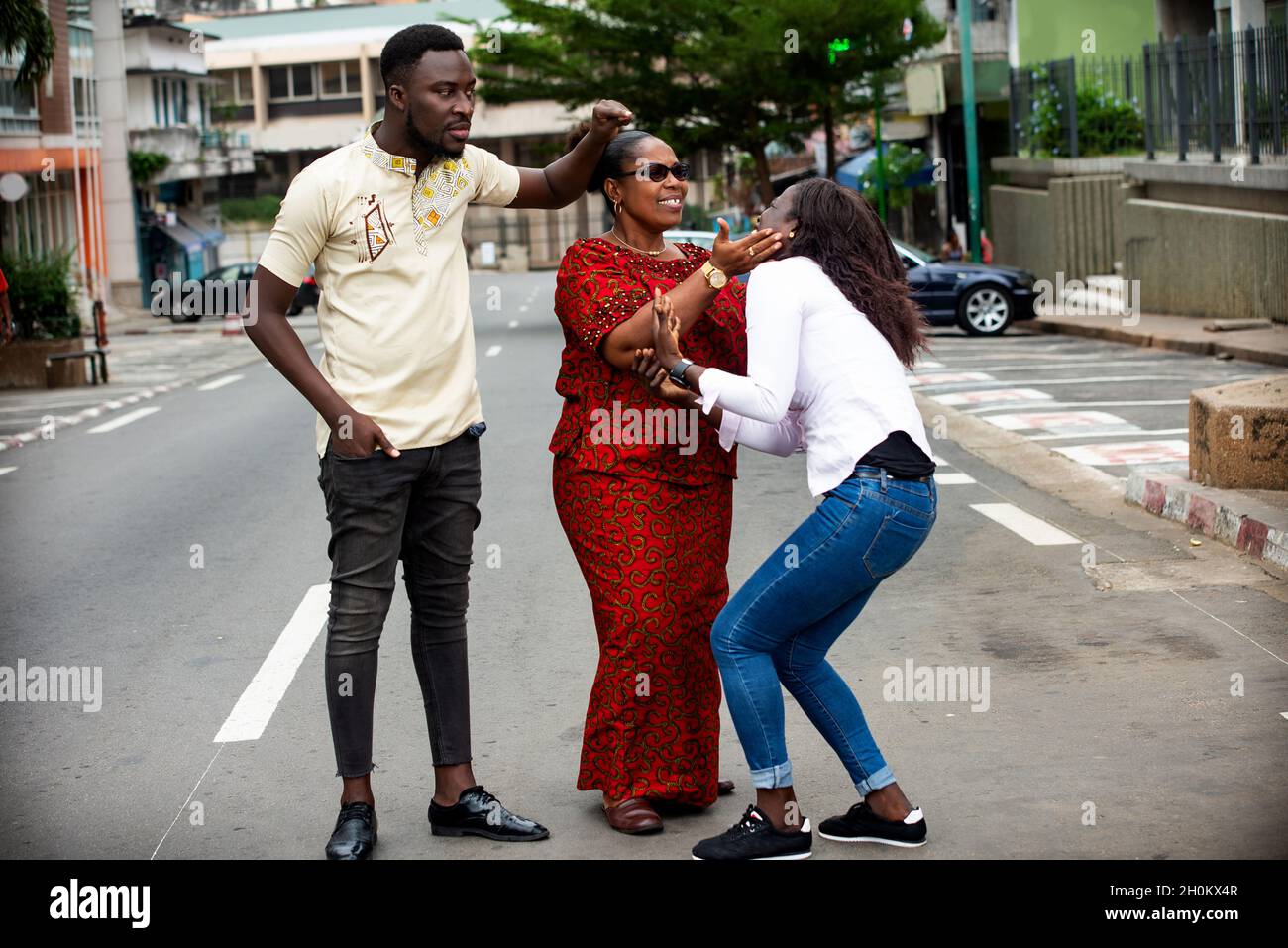 beautiful happy family standing and walking outdoors in the street ...