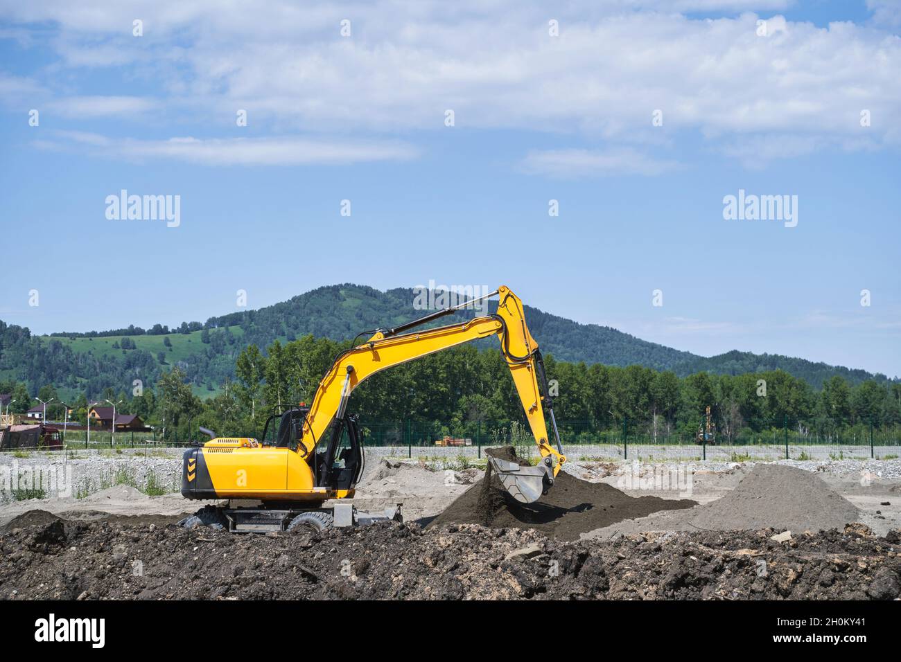Demolition constuction. Excavator machine build road at mountain Stock ...