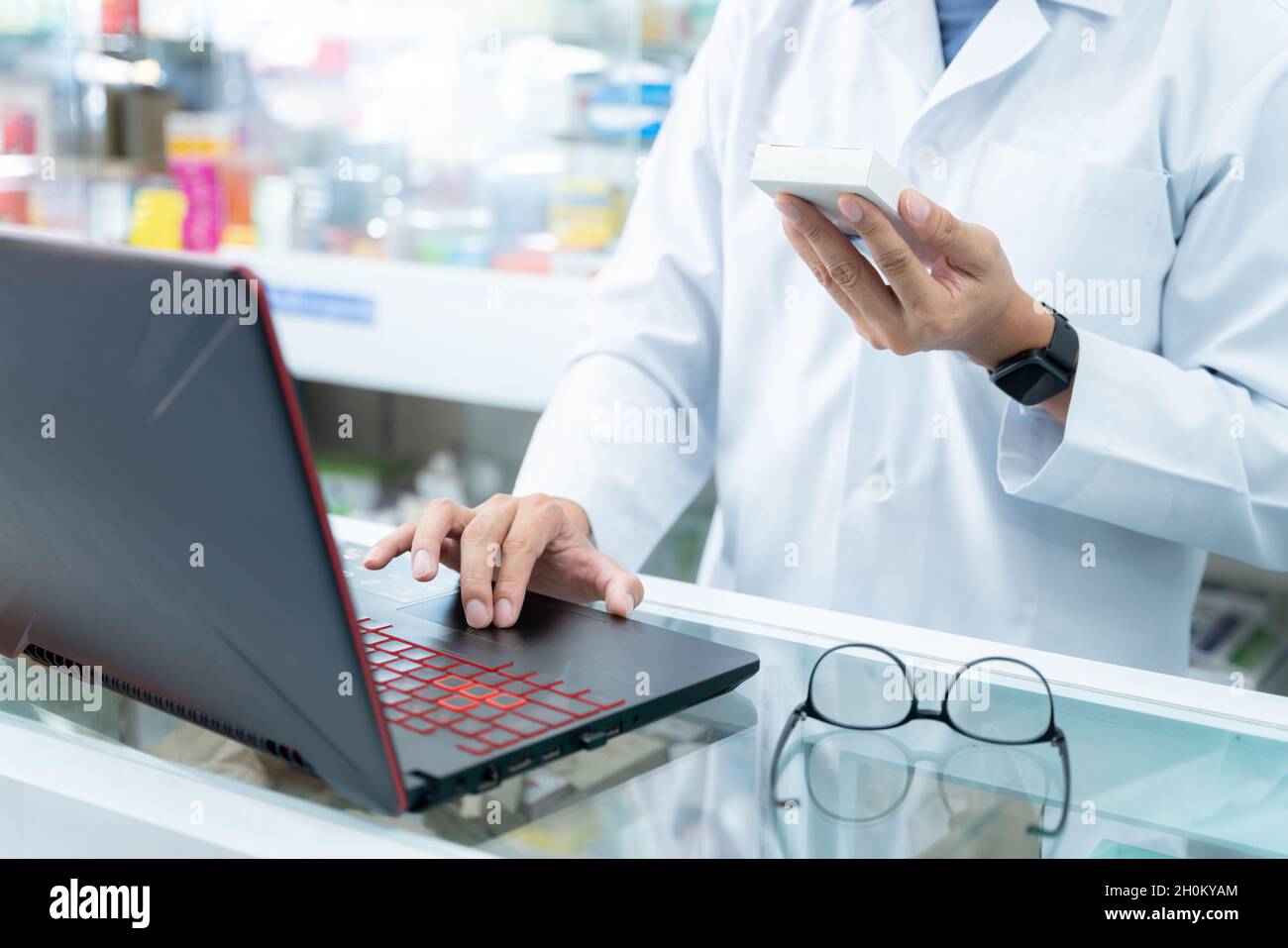 close up hand of a male pharmacist working at pharmacy. Medical ...