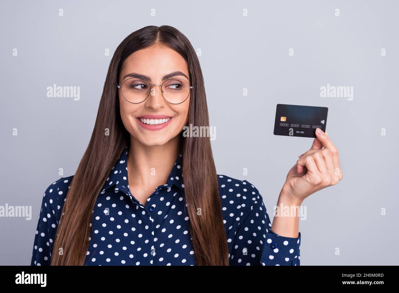 Photo of curious smart banker lady hold credit card look side wear ...