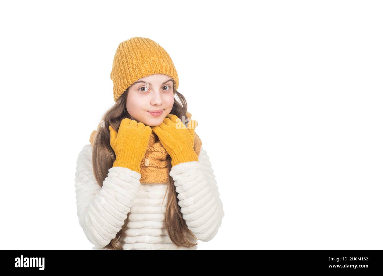 cheerful teen girl in knitted hat scarf and gloves isolated on white ...