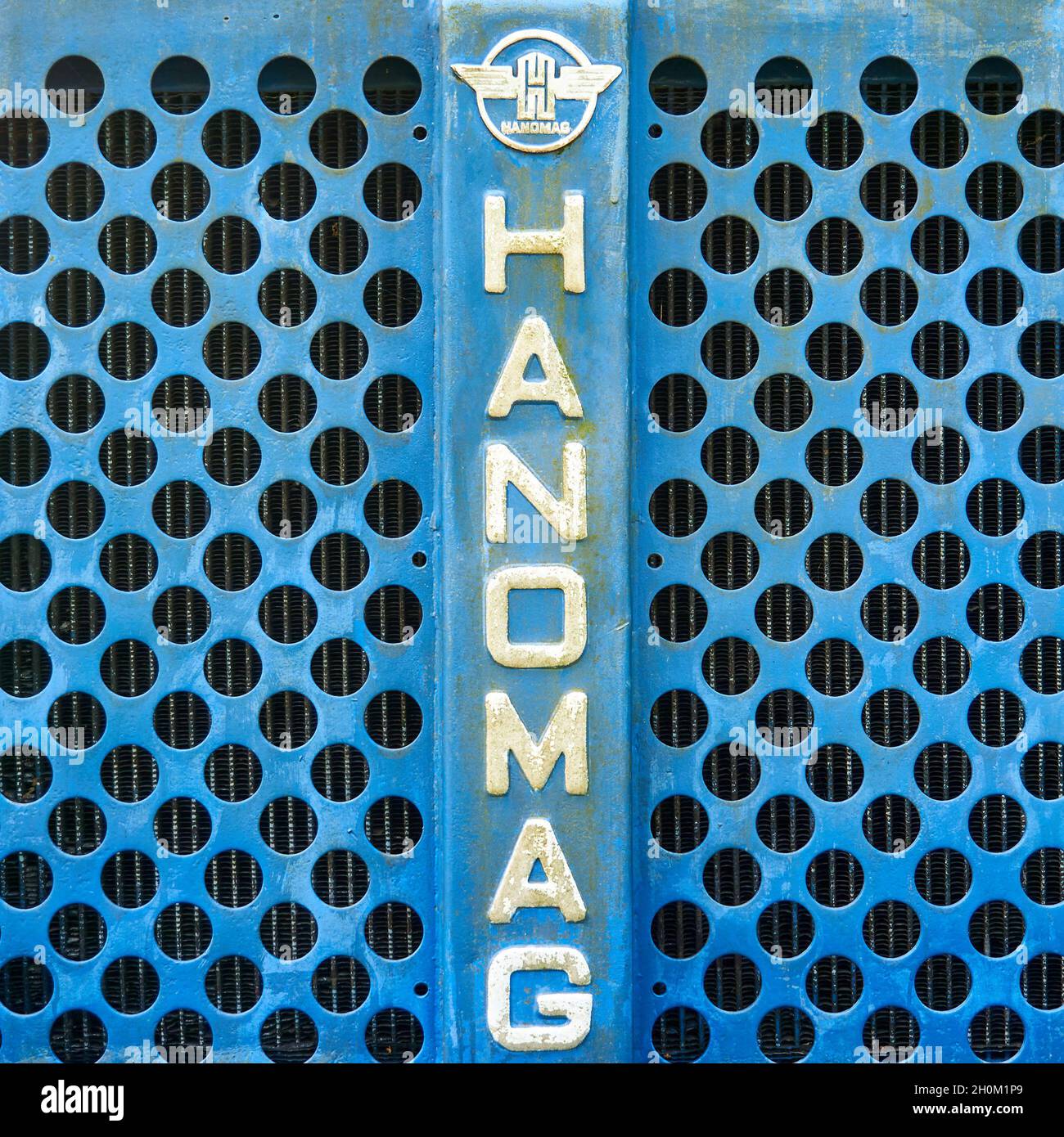 Hanomag lettering and logo, vertically out of blue perforated metal ...