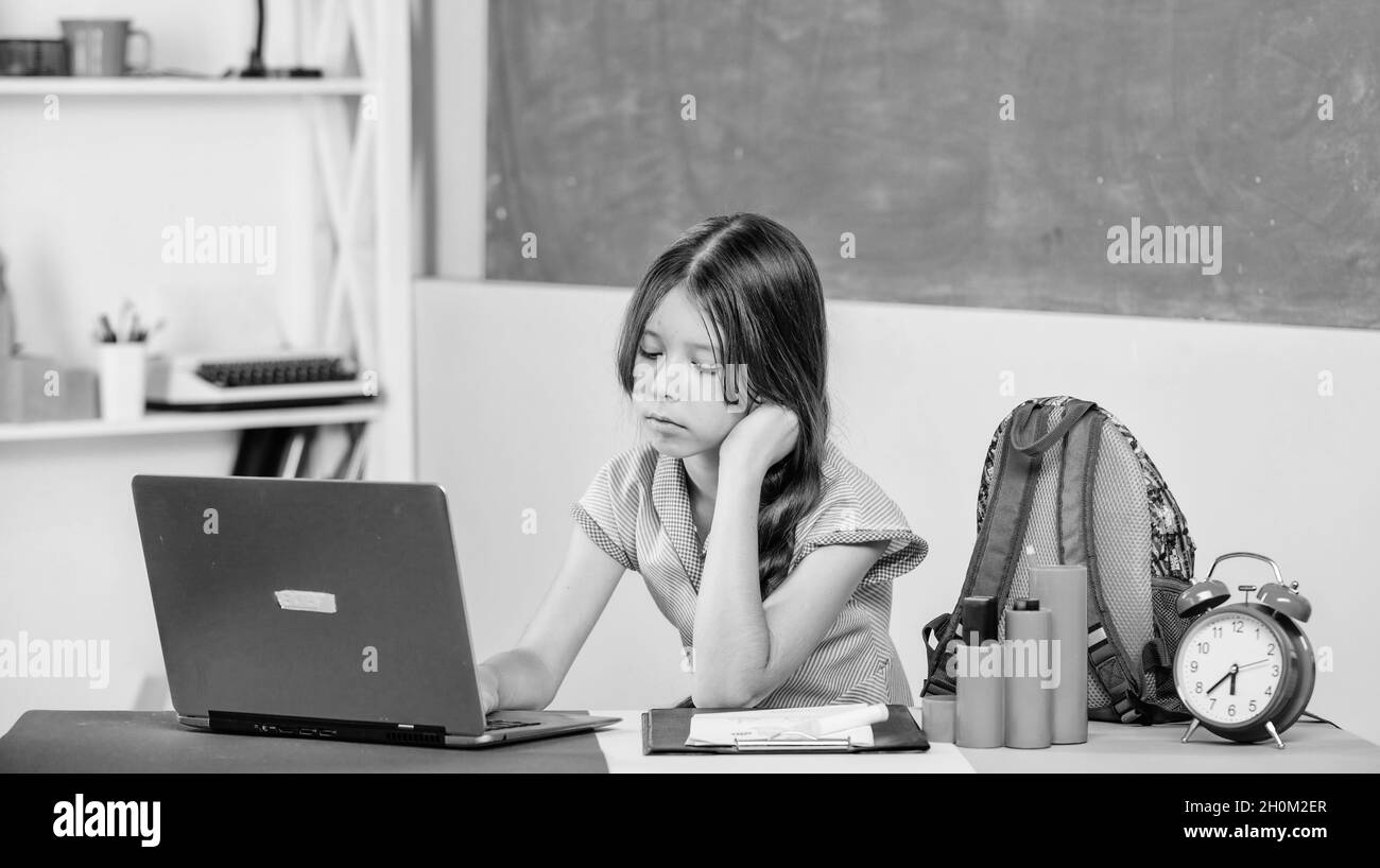 small girl pupil with computer. Use new technology. study online ...