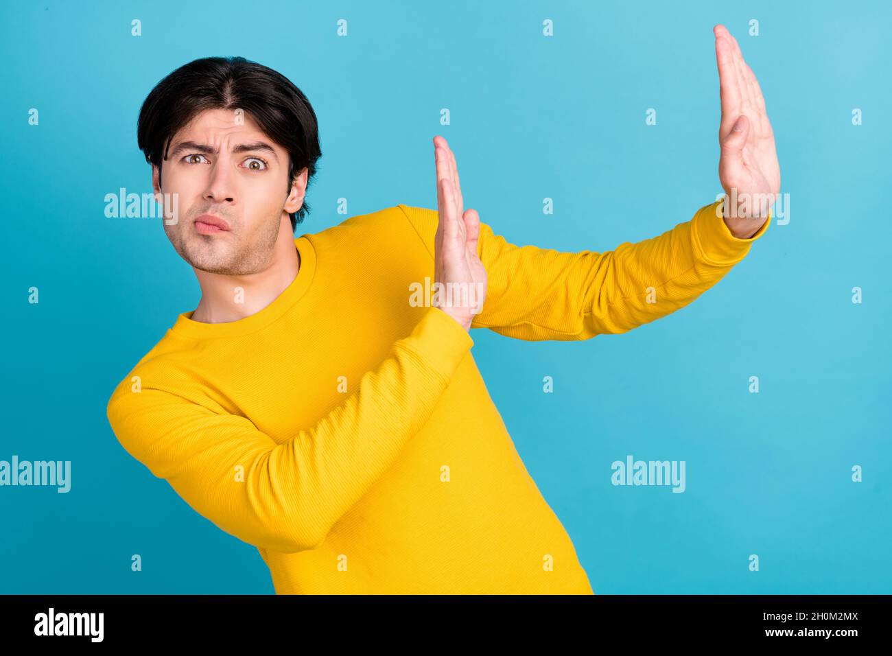 Photo of millennial brunet guy show no wear yellow shirt isolated on ...