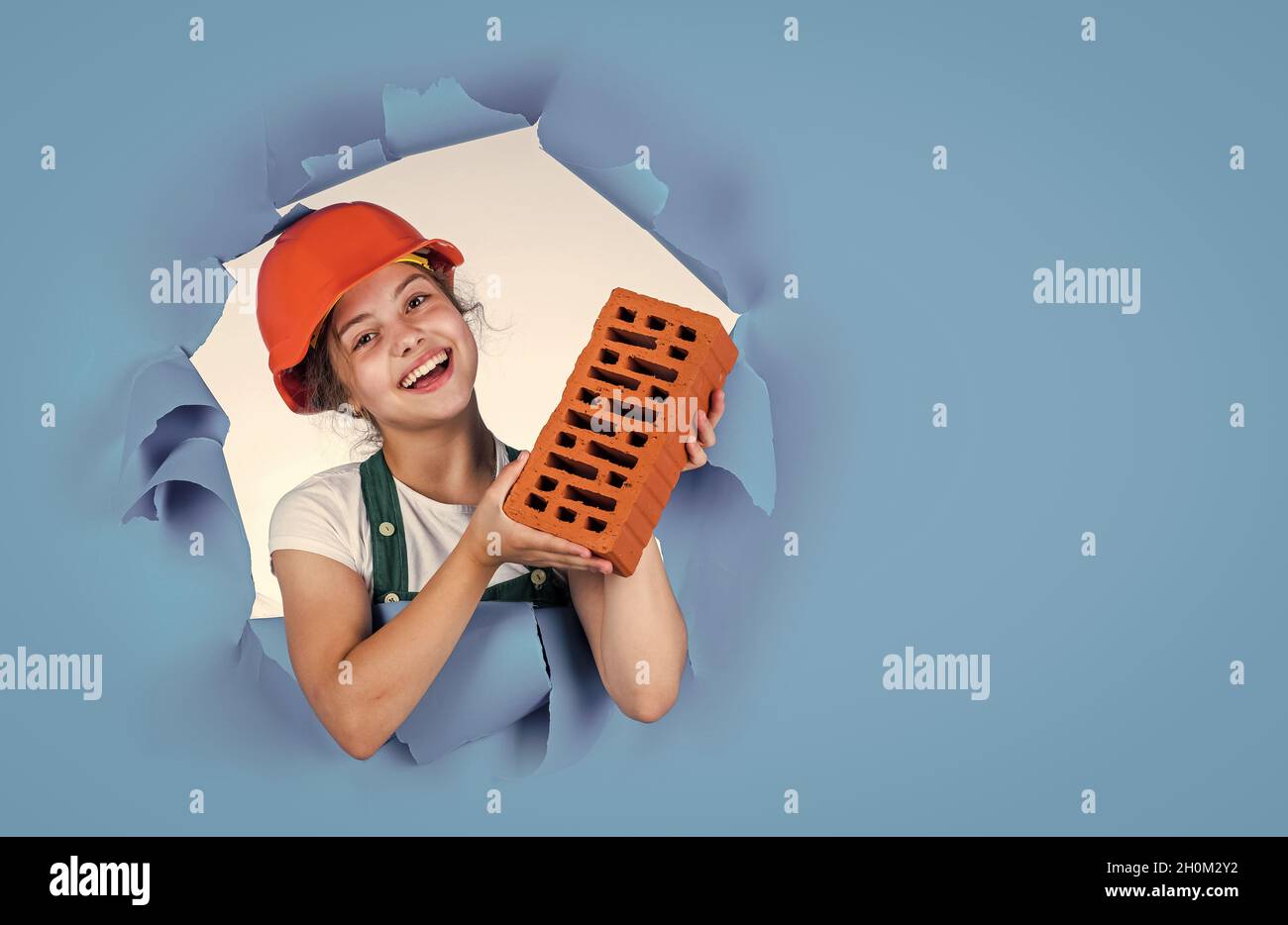 Real professional. kid wear helmet on construction site. teen girl ...