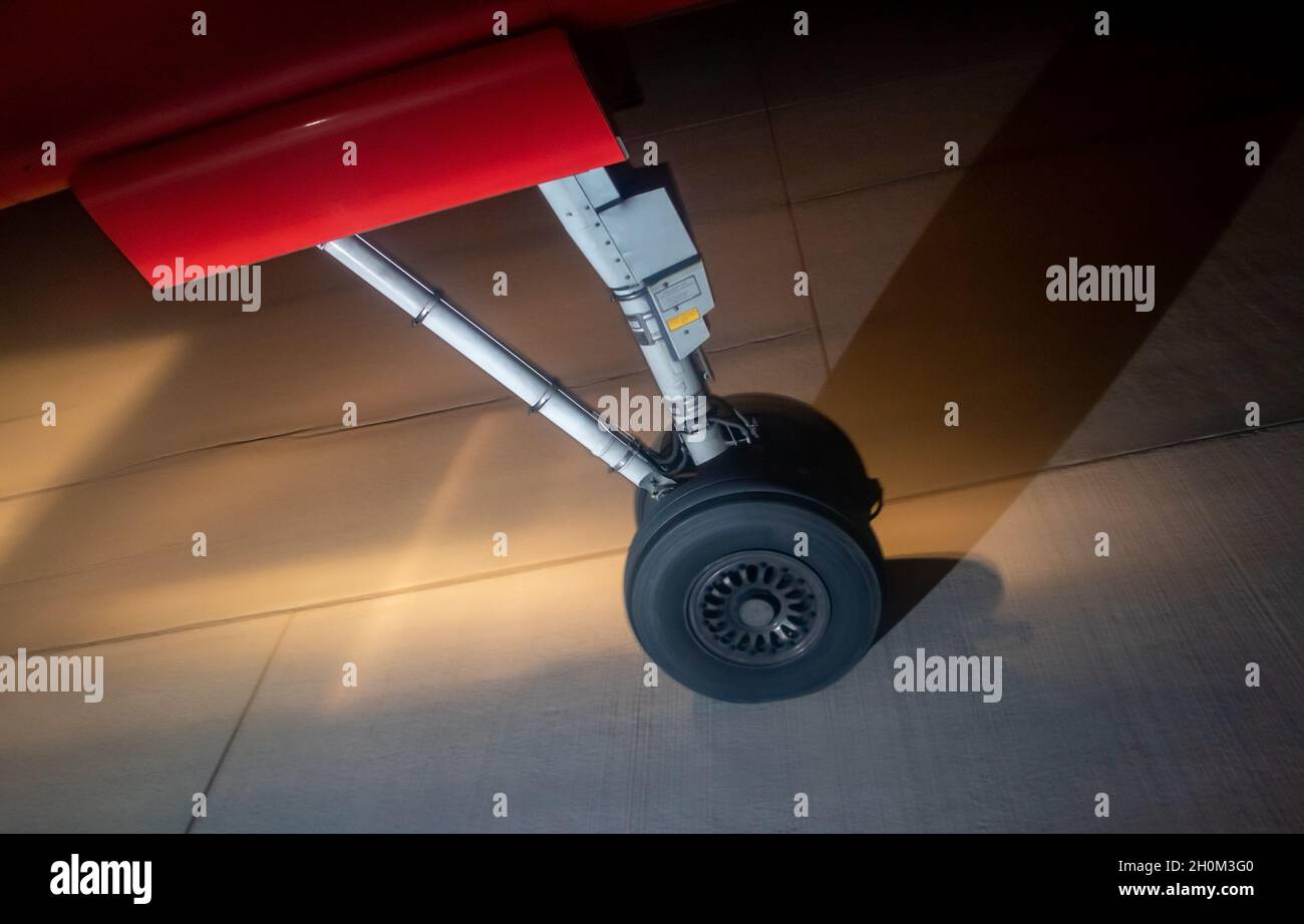 A wheel of an airplane rides on a night runway Stock Photo - Alamy