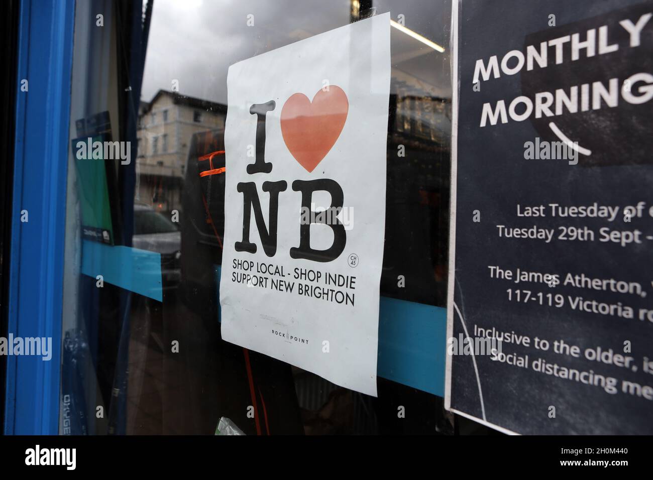 A ‘Shop Local’ poster in a shop window in the area of New Brighton in ...