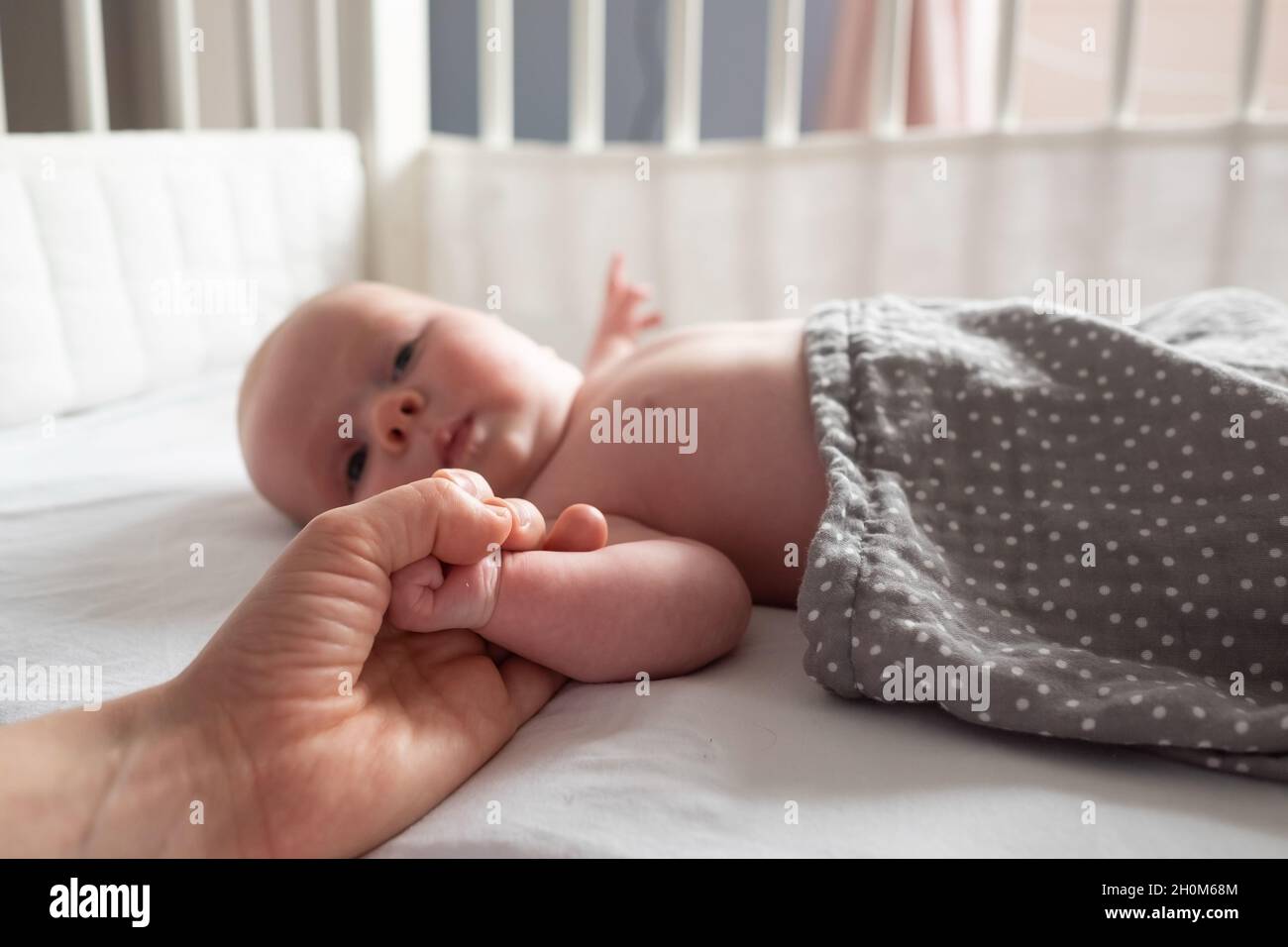 Baby girl paying with his mother in bed Stock Photo - Alamy