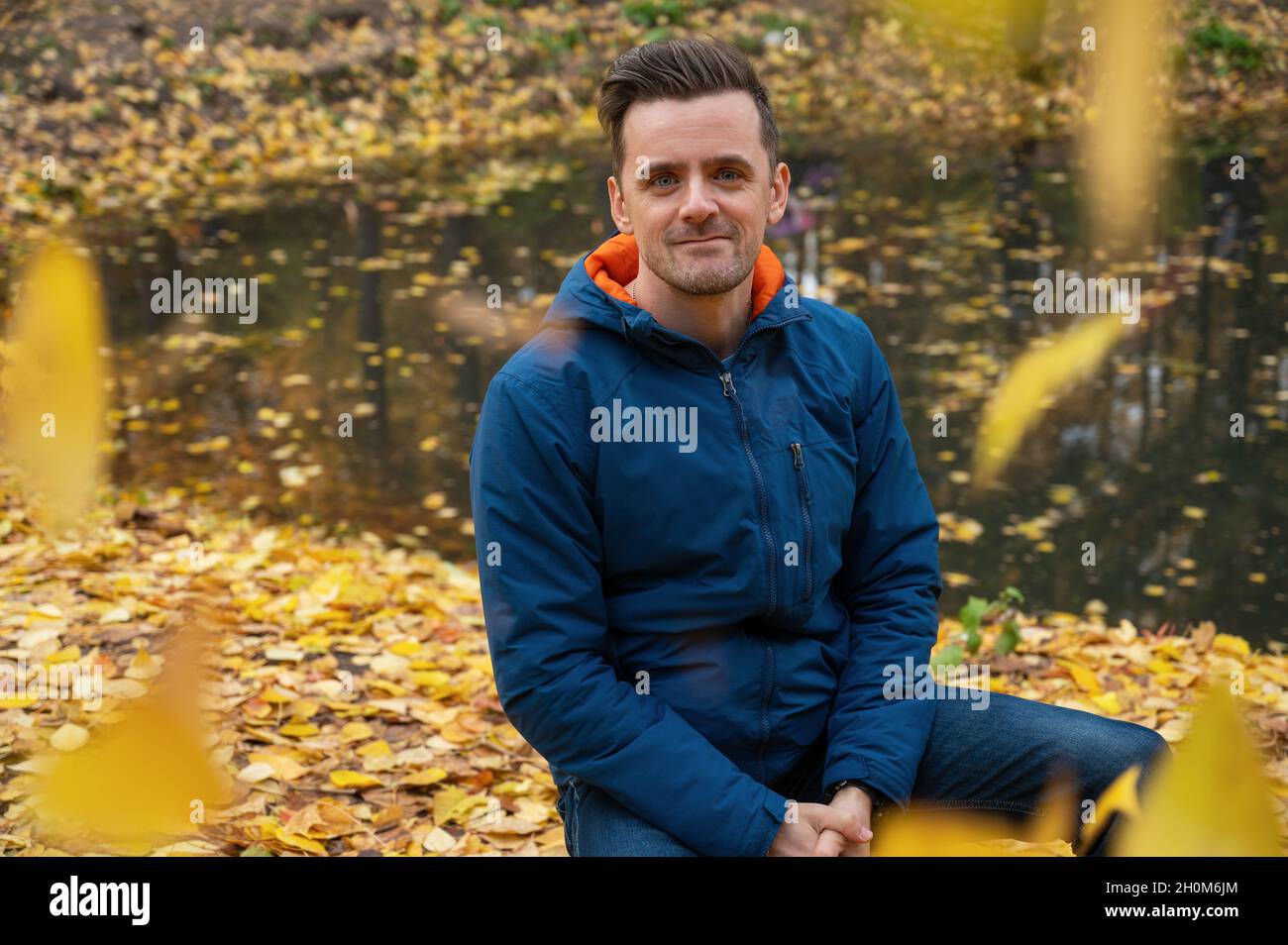 Autumn portrait of man on fall nature background Stock Photo - Alamy