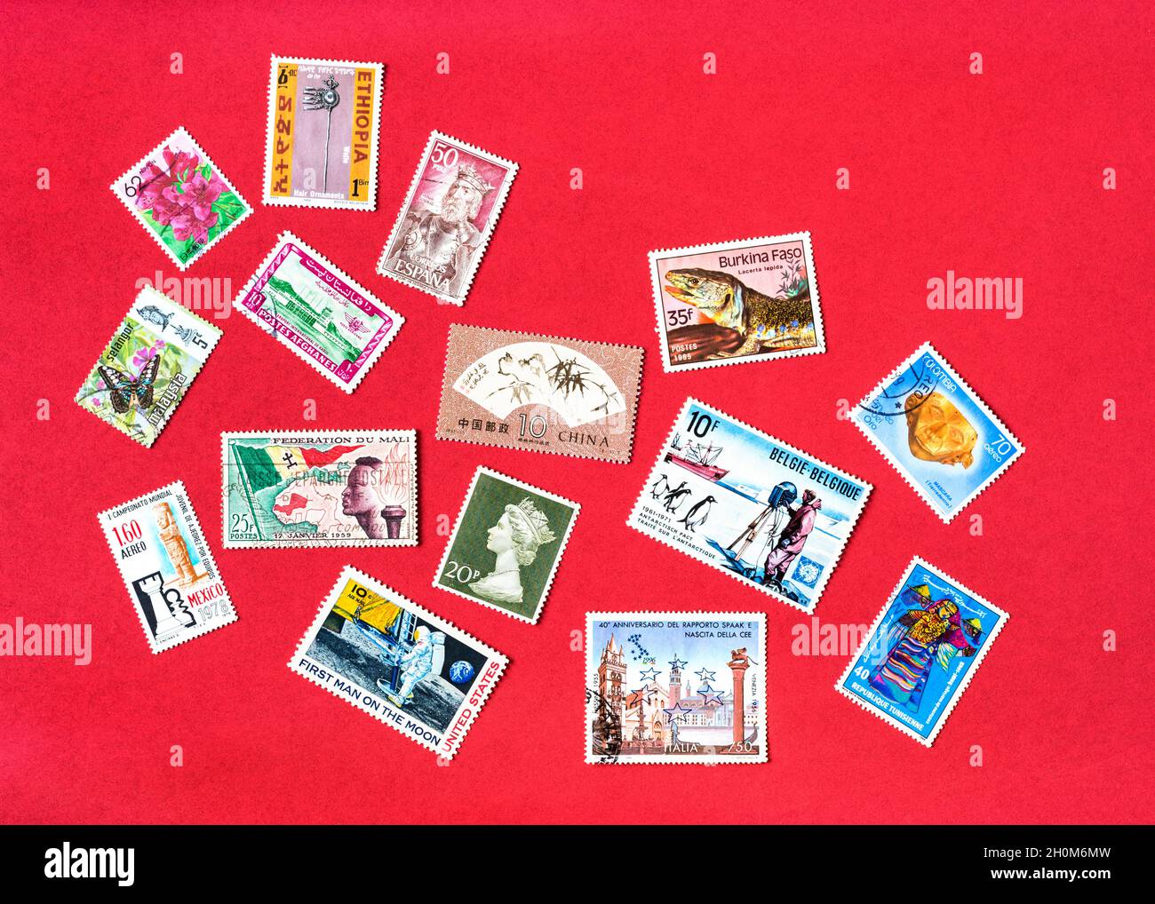 Various postage stamps from around the world on red background Stock ...