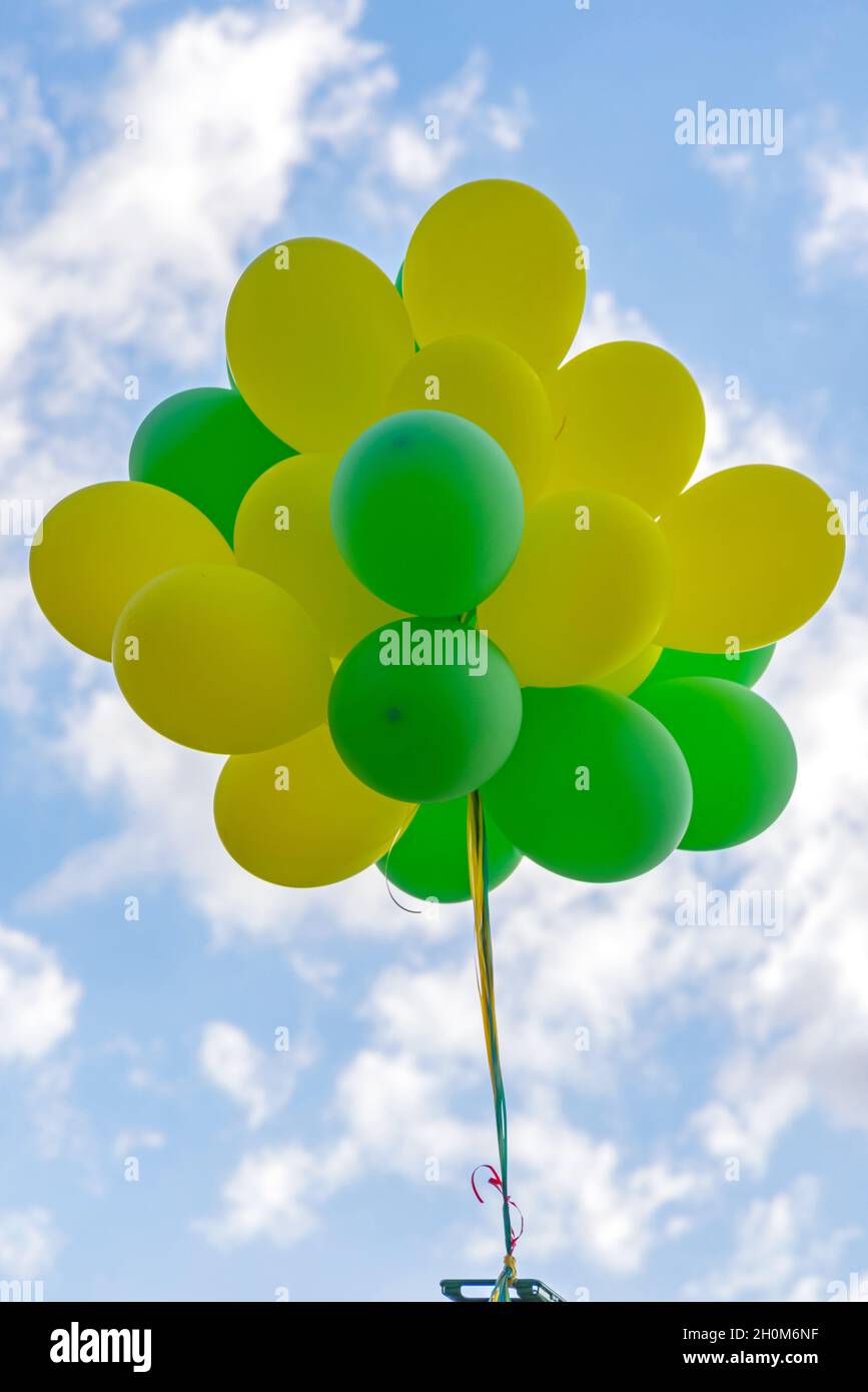 Yellow and Green Helium Balloons Cluster at Cloudy Sky Stock Photo - Alamy