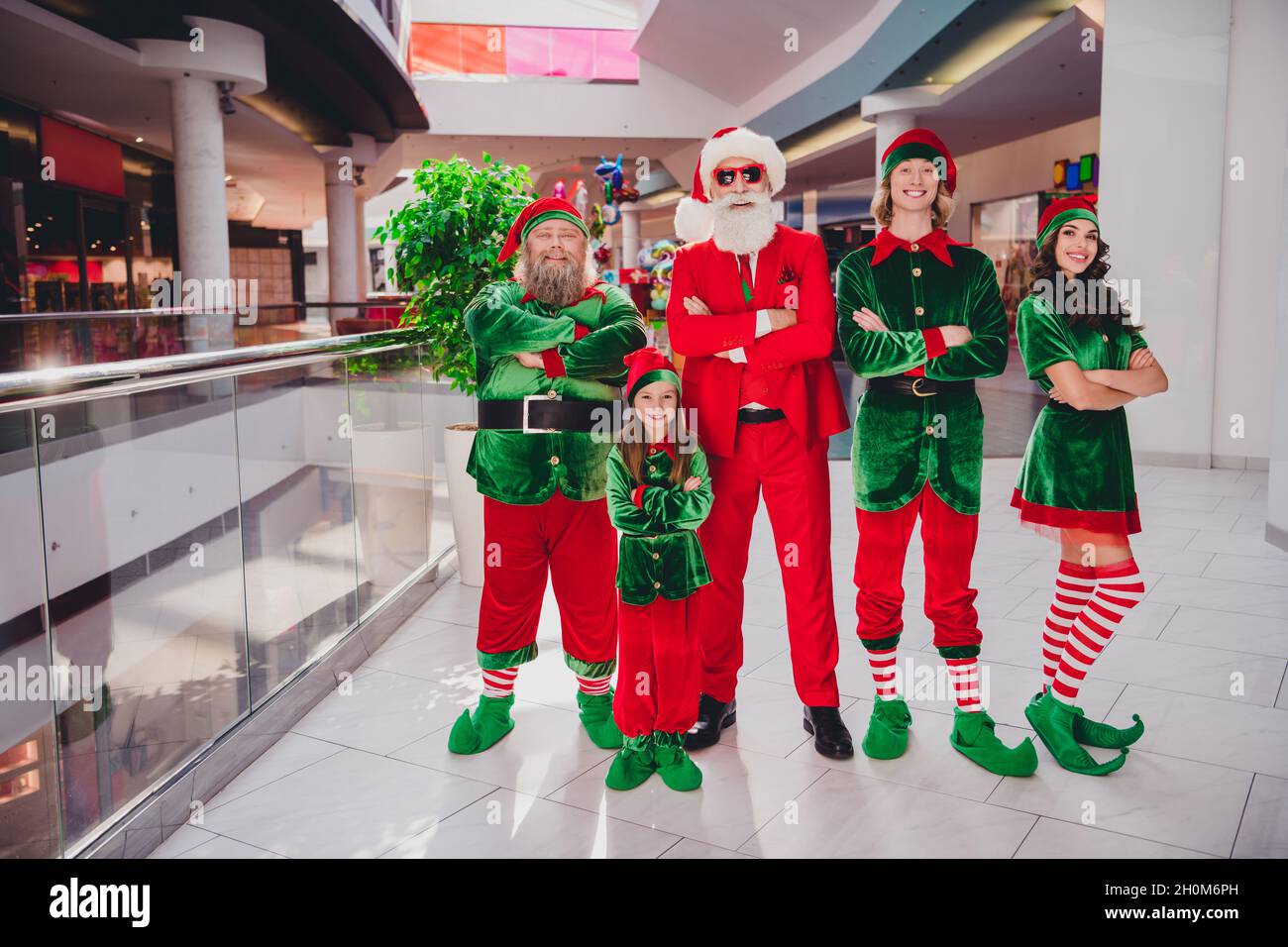 Photo of five cheerful x-mas role-play people entertain store customers ...