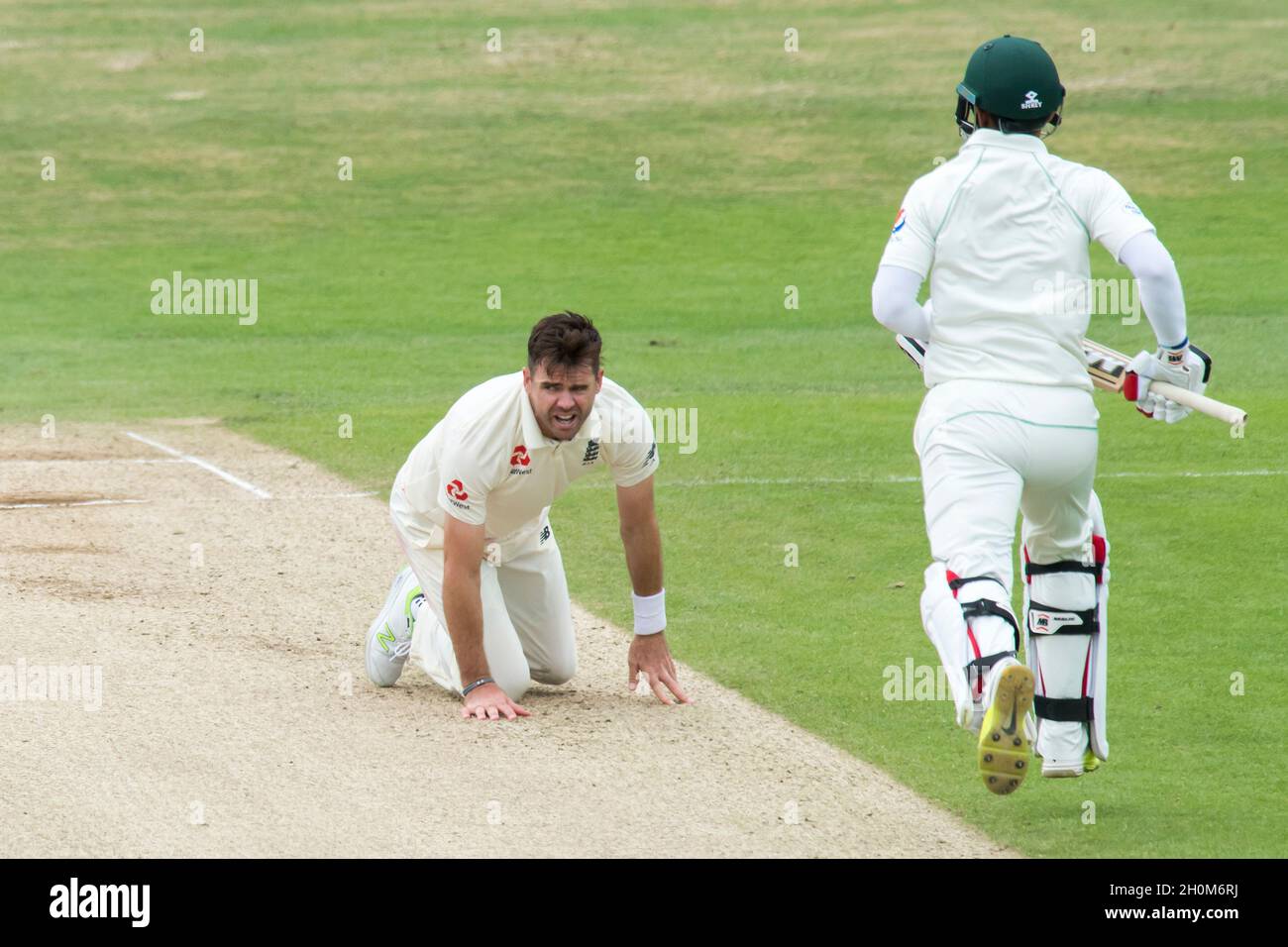 England’s James Anderson reacts as he falls over whilst bowling Stock ...