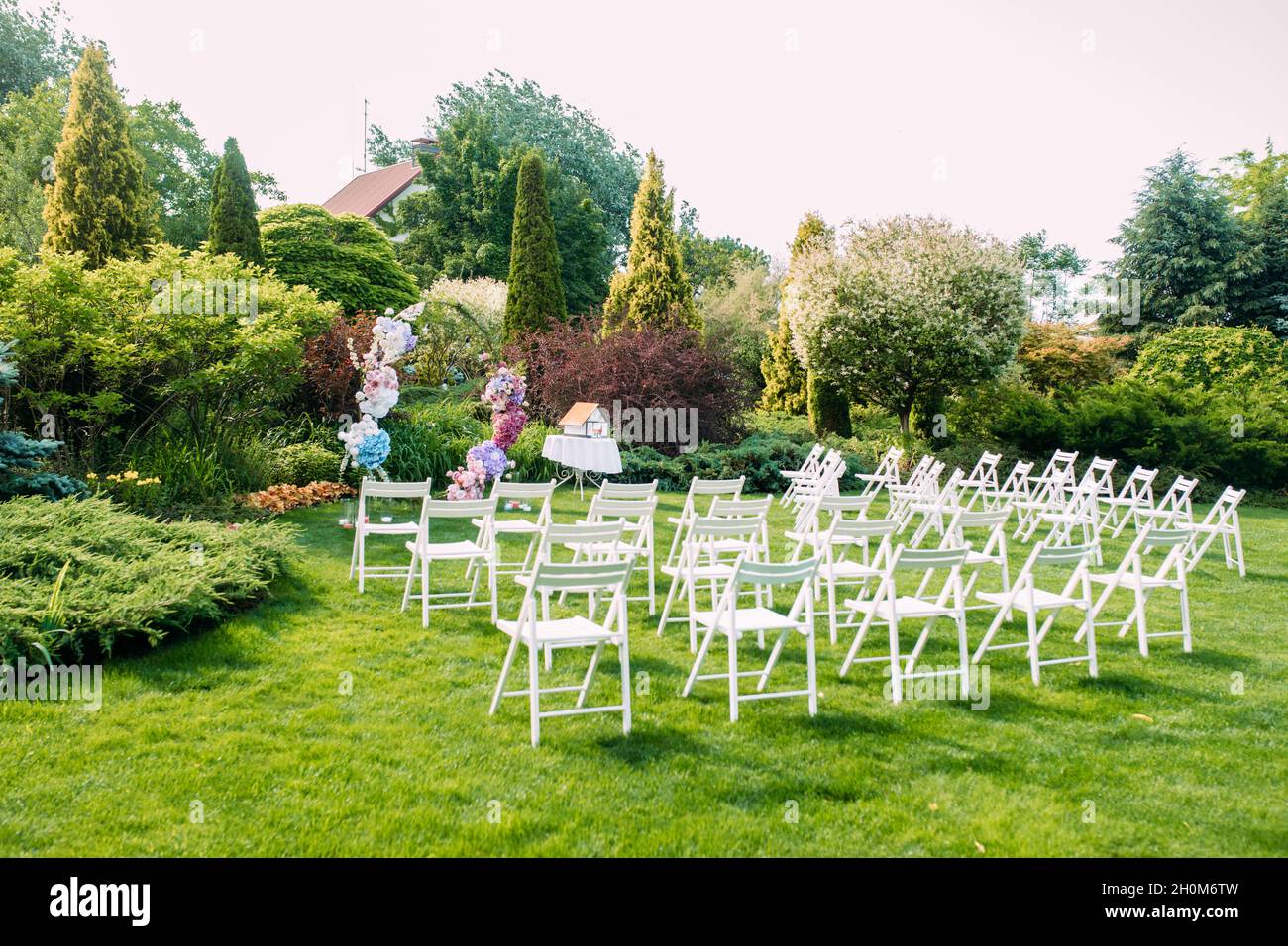 Wedding ceremony in the beautiful landscaping garden among lawn with ...