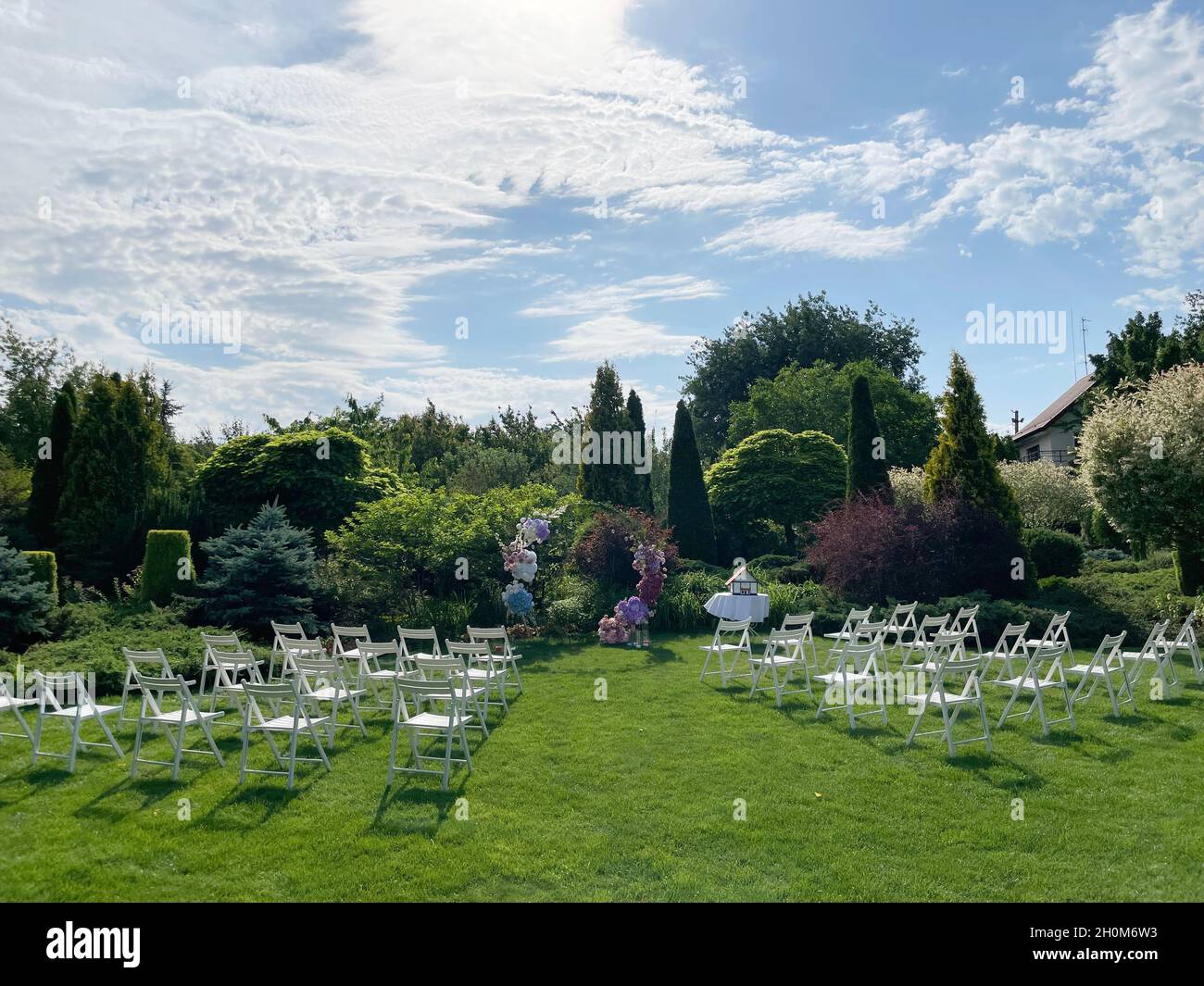 Wedding ceremony in the beautiful landscaping garden among lawn with ...
