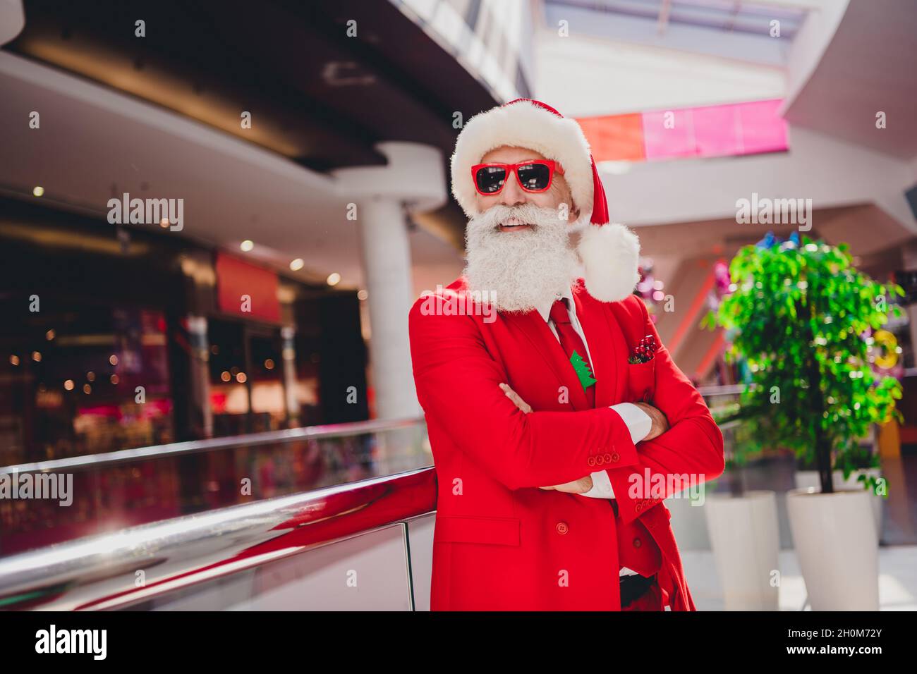 Photo of trendy confident handsome santa claus wear dark eyewear arms ...