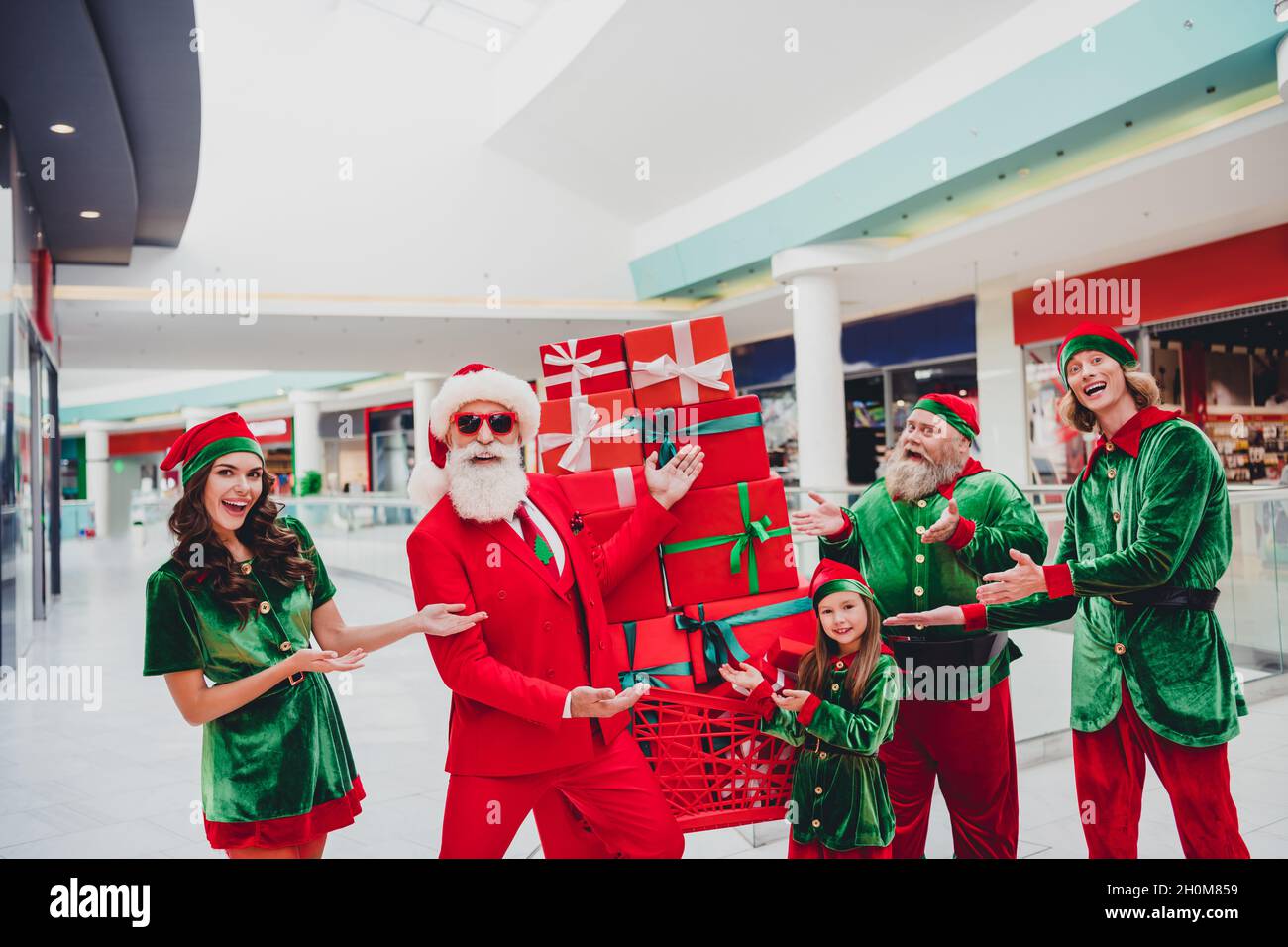 Photo of handsome excited santa claus assistants wear costumes smiling ...