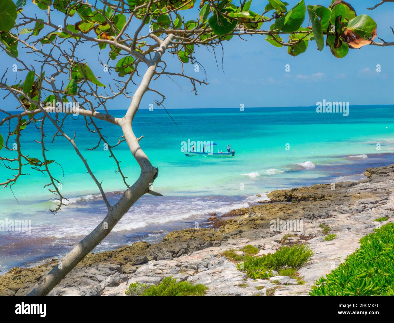 Beautiful and sunny seaside with blue clean water and guys on the boat ...