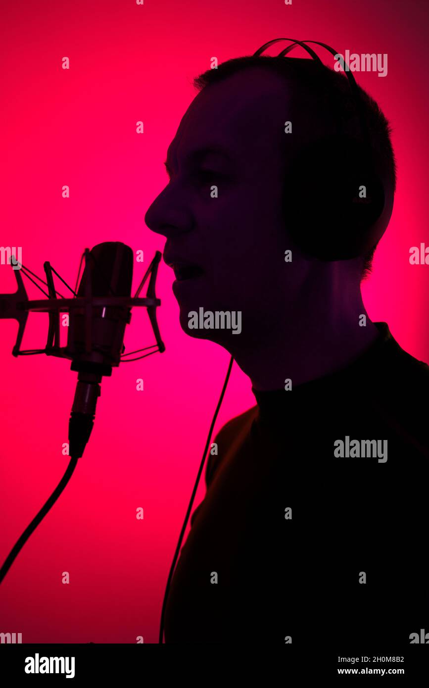 Voiceover artist voice actor in vocal recording studio with larg ...