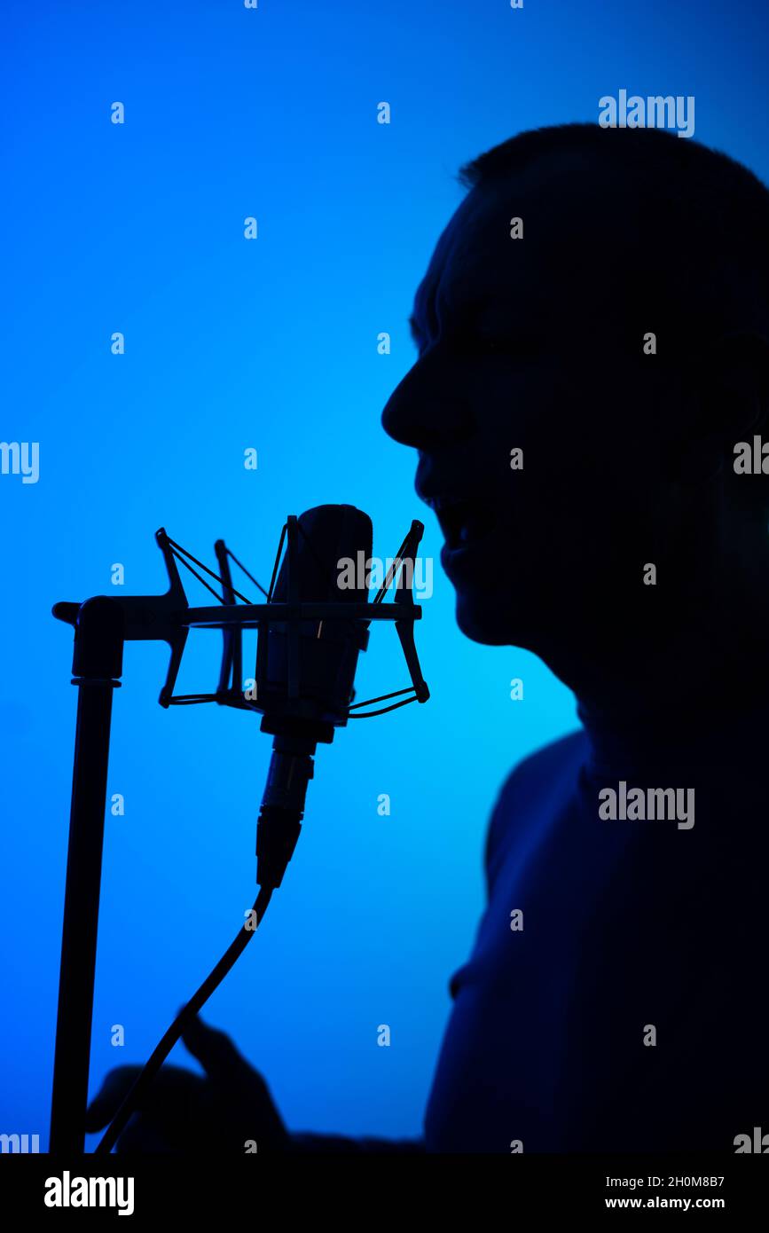 Voiceover artist voice actor in vocal recording studio with larg ...