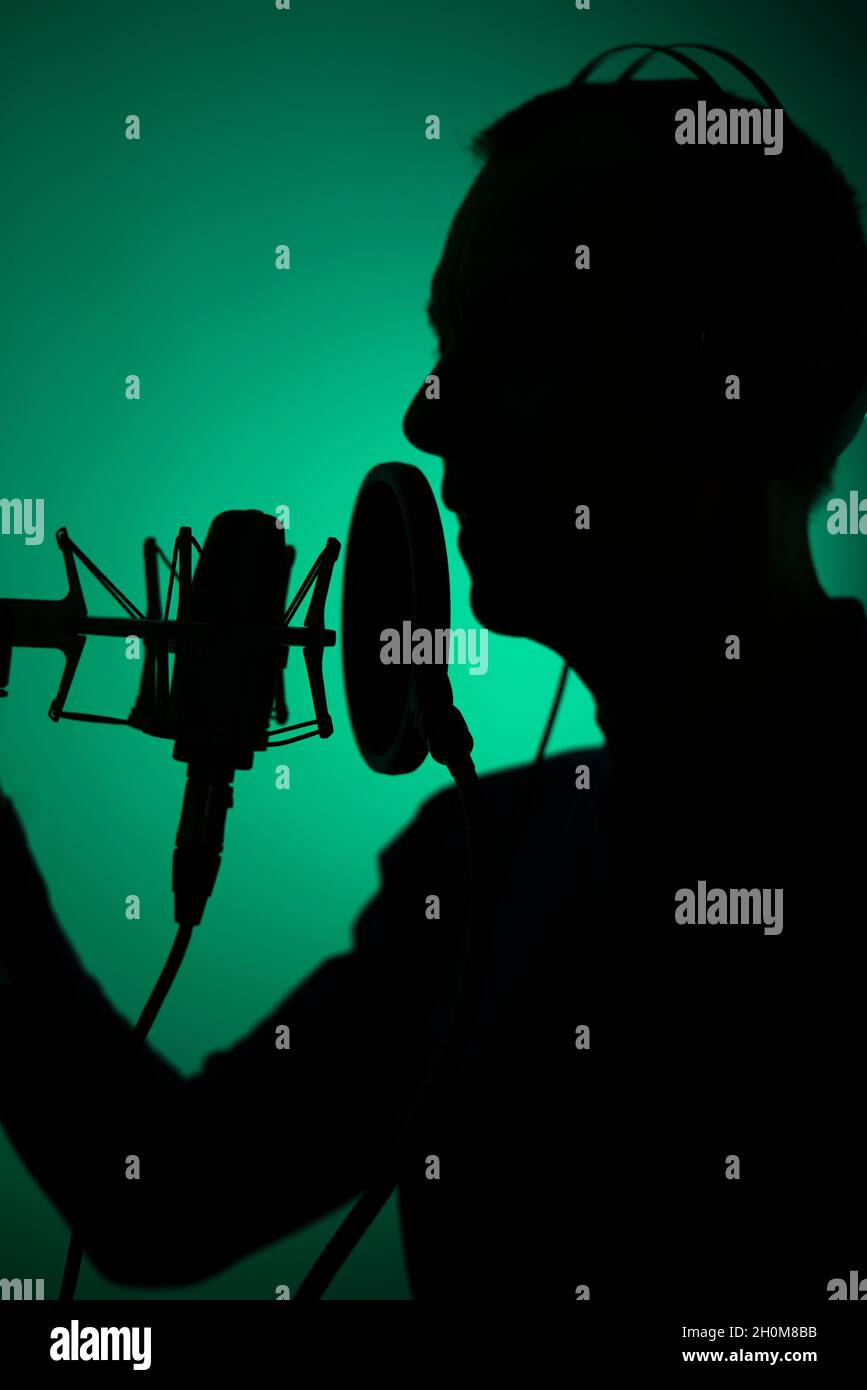 Voiceover artist voice actor in vocal recording studio with larg ...