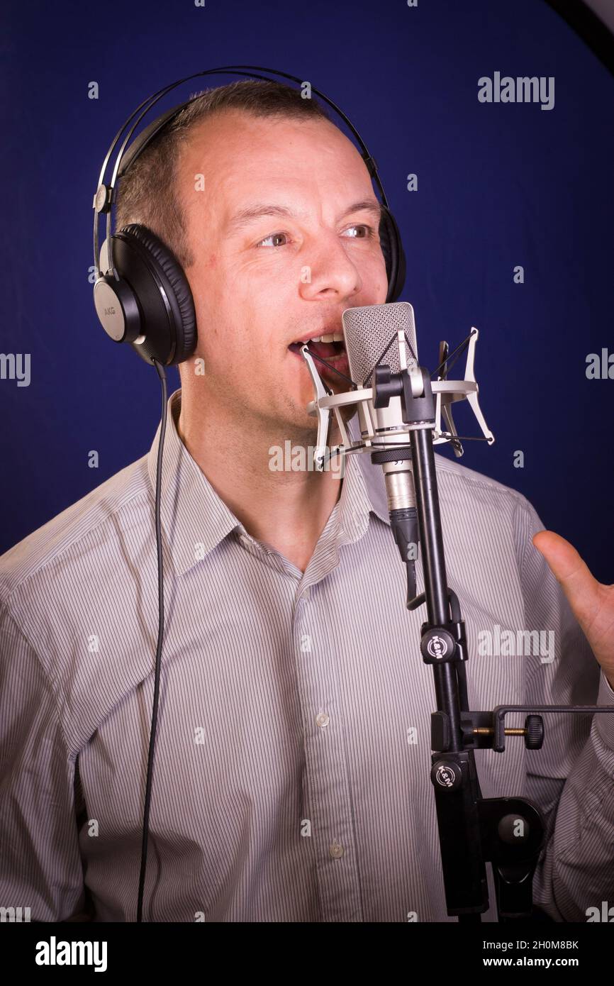 Voiceover artist voice actor in vocal recording studio with larg ...