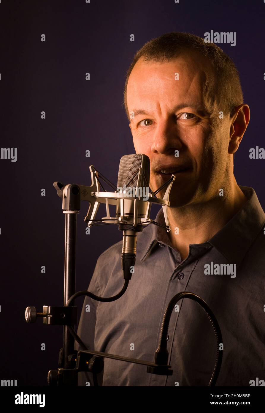 Voiceover artist voice actor in vocal recording studio with larg ...